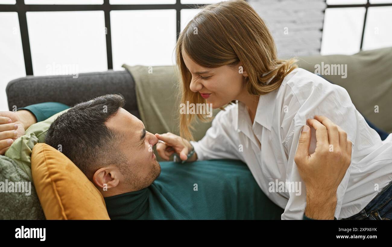A loving couple enjoys a cozy moment together on a couch in a modern ...