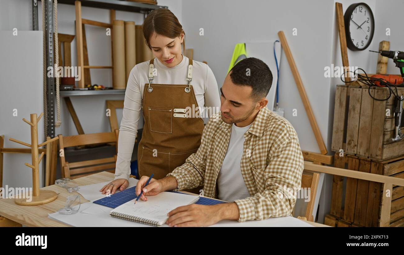 A woman and man collaborate in a carpentry workshop, crafting with focus and teamwork indoors ...