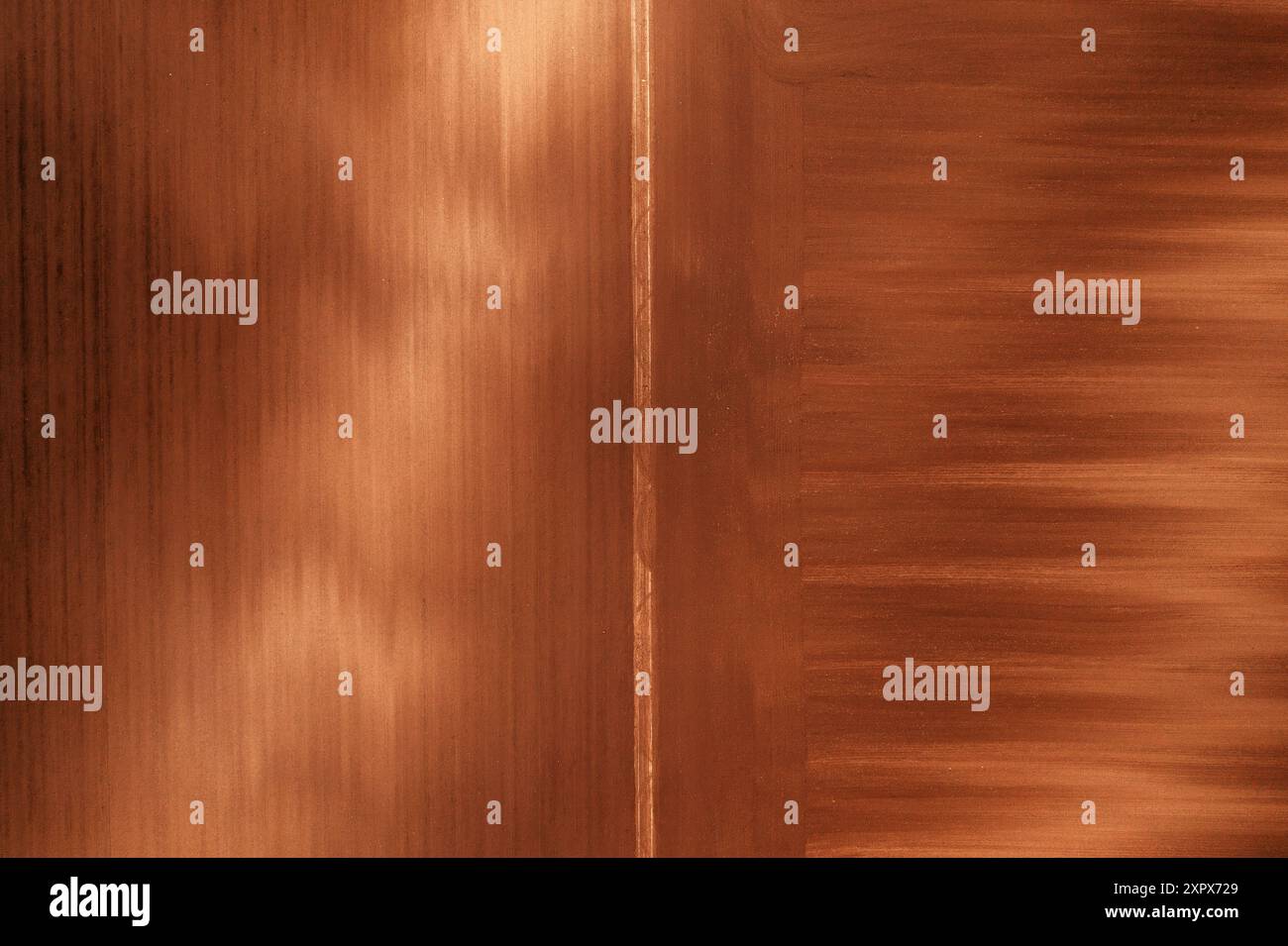 Aerial view of dusty dirt road splitting the tilled agricultural field ...