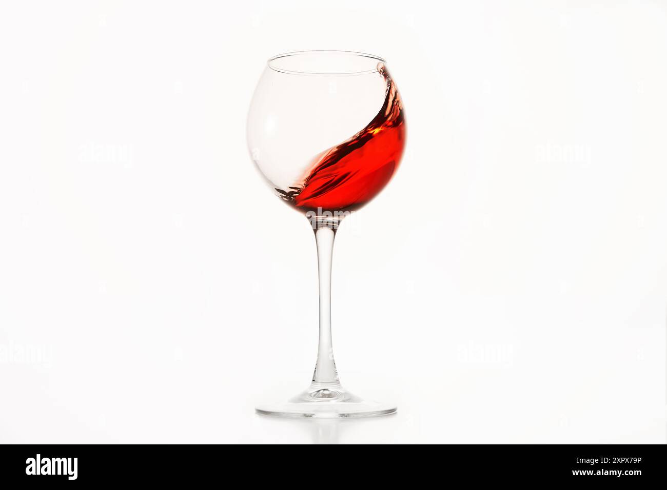 Diagonal wave of rose wine, alcohol is in glass on white isolated Stock ...