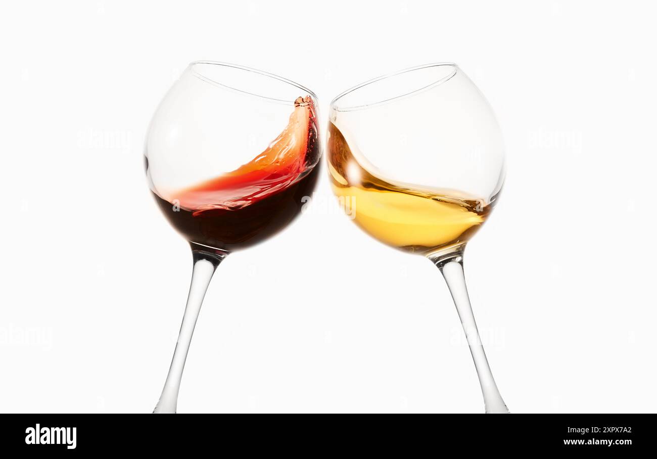 Glasses of red, white wine clink during toast Stock Photo - Alamy