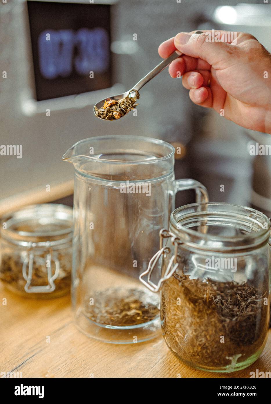 spoon with green tea. Natural hot drink preparation. Home kitchen interior. Jars of spices Stock ...