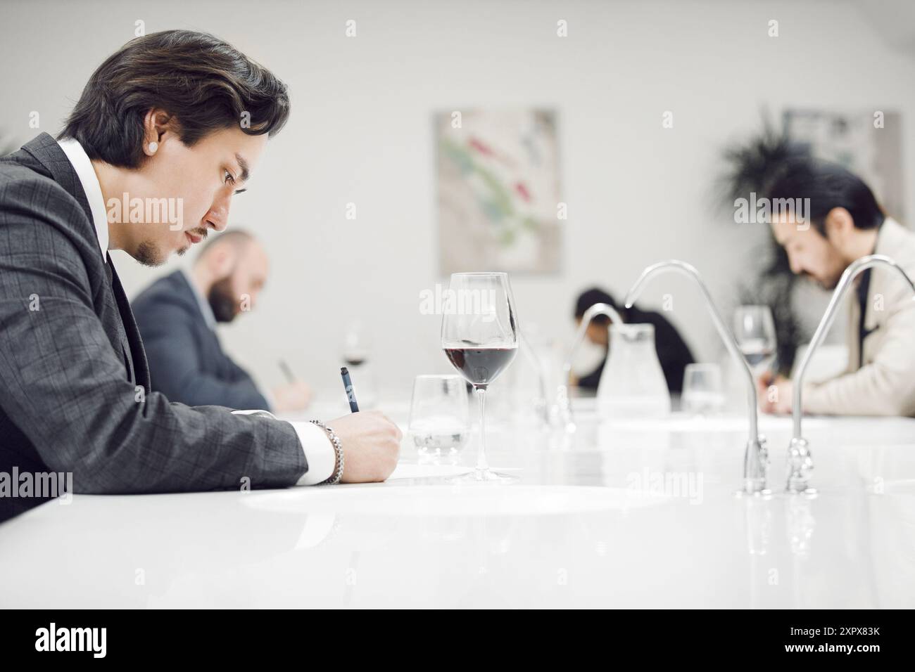 Professional Sommeliers Participants Tasting Red Wine during Blind ...