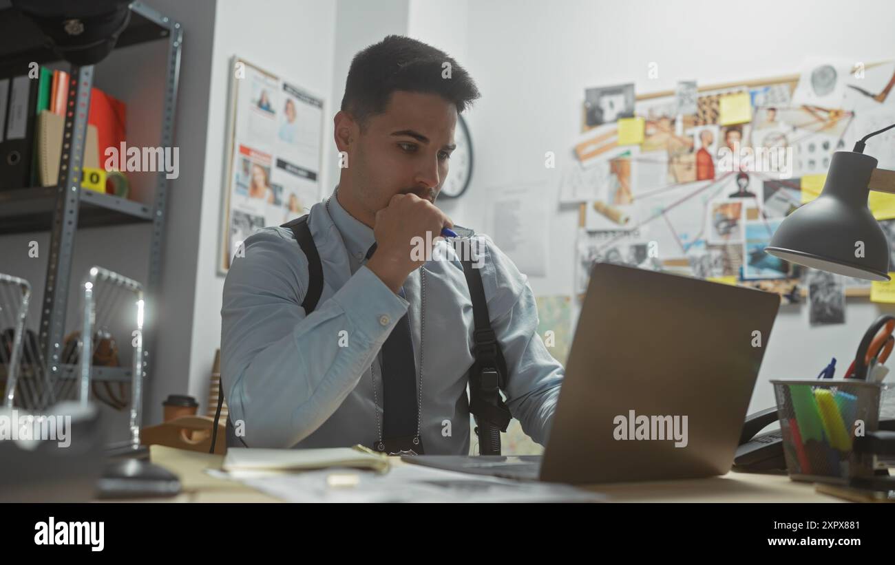 Young hispanic man thinking at police station with laptop, evidence ...