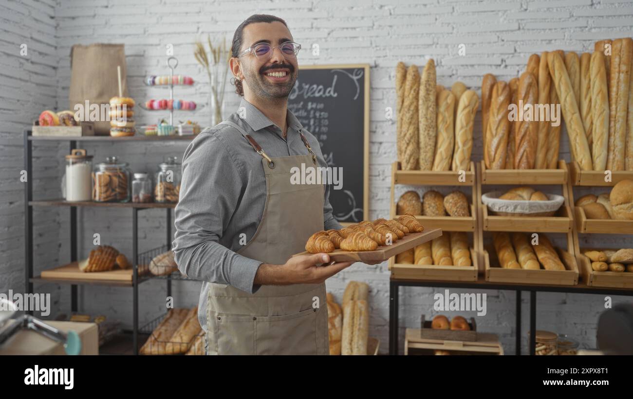 Young hispanic man with moustache smiling while holding a tray of ...