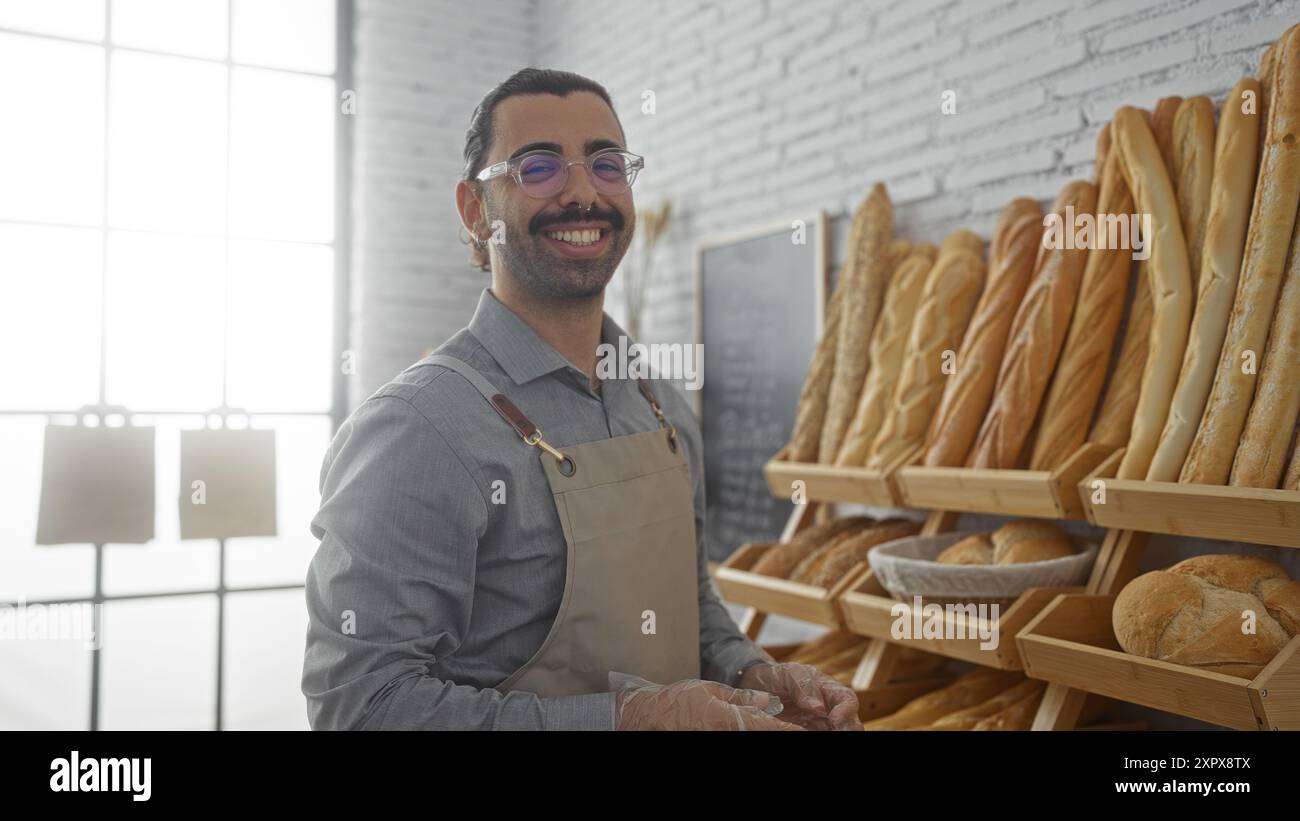 Handsome young hispanic man with a moustache standing in a bakery shop ...