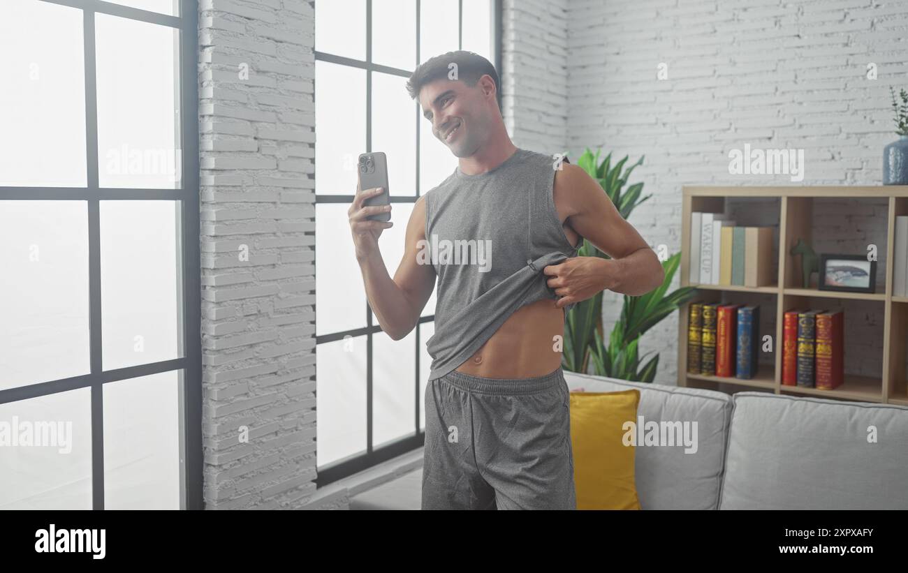A fit young man taking a selfie showing his abs in a modern, well-lit ...