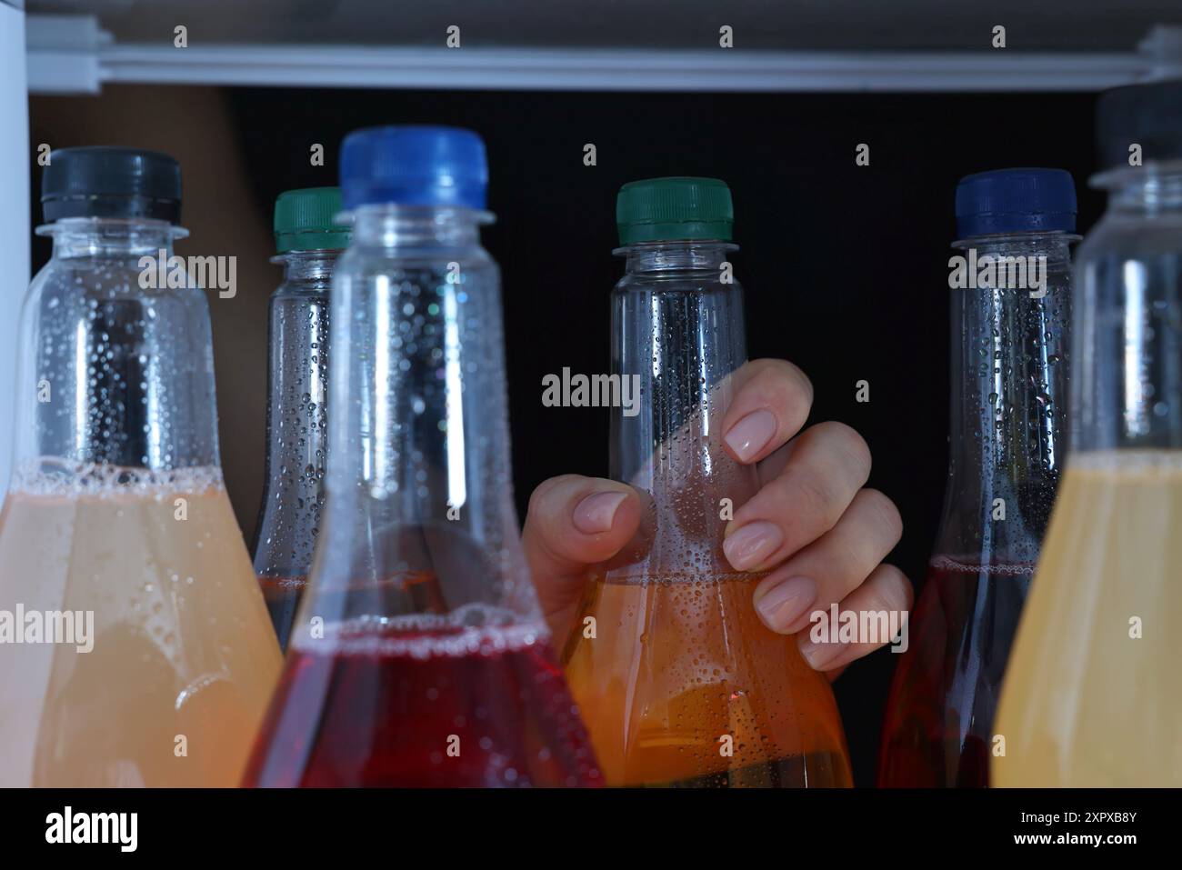 Woman taking bottle of soda drink from refrigerator, closeup Stock ...