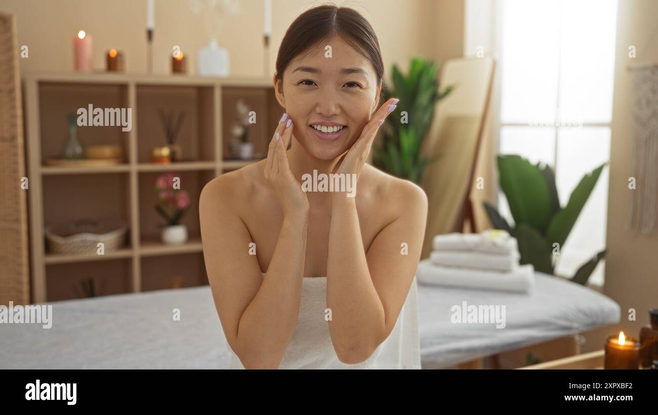 Young chinese woman relaxing indoors at a spa salon, gently touching ...