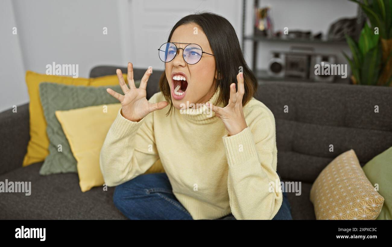 Hispanic woman shouting frustration indoors living room Stock Photo - Alamy
