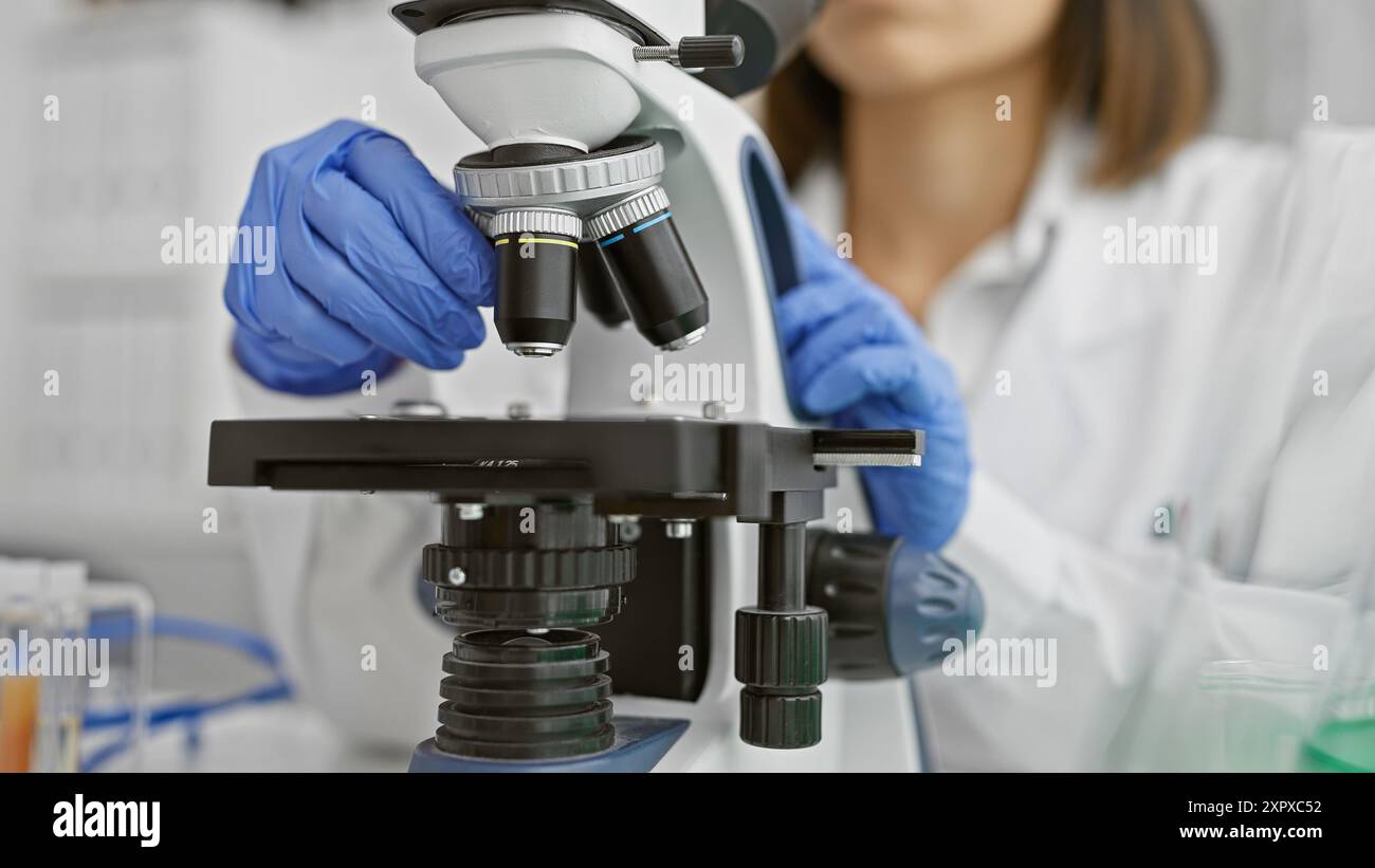 A professional scientist intensely focuses on a specimen through a ...