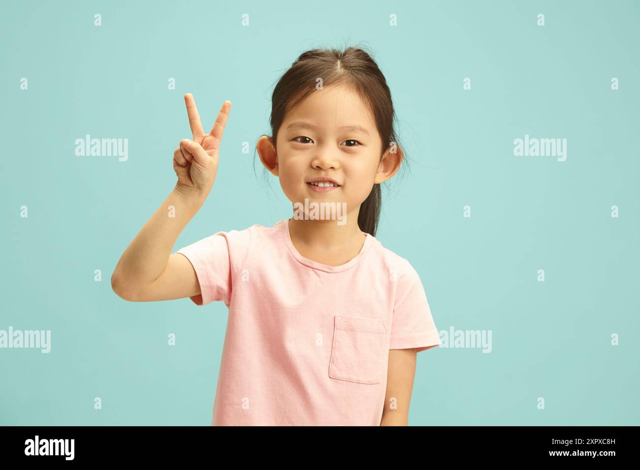 Cute Asian ethnicity Child Giving Peace Sign, studio isolated portrait ...