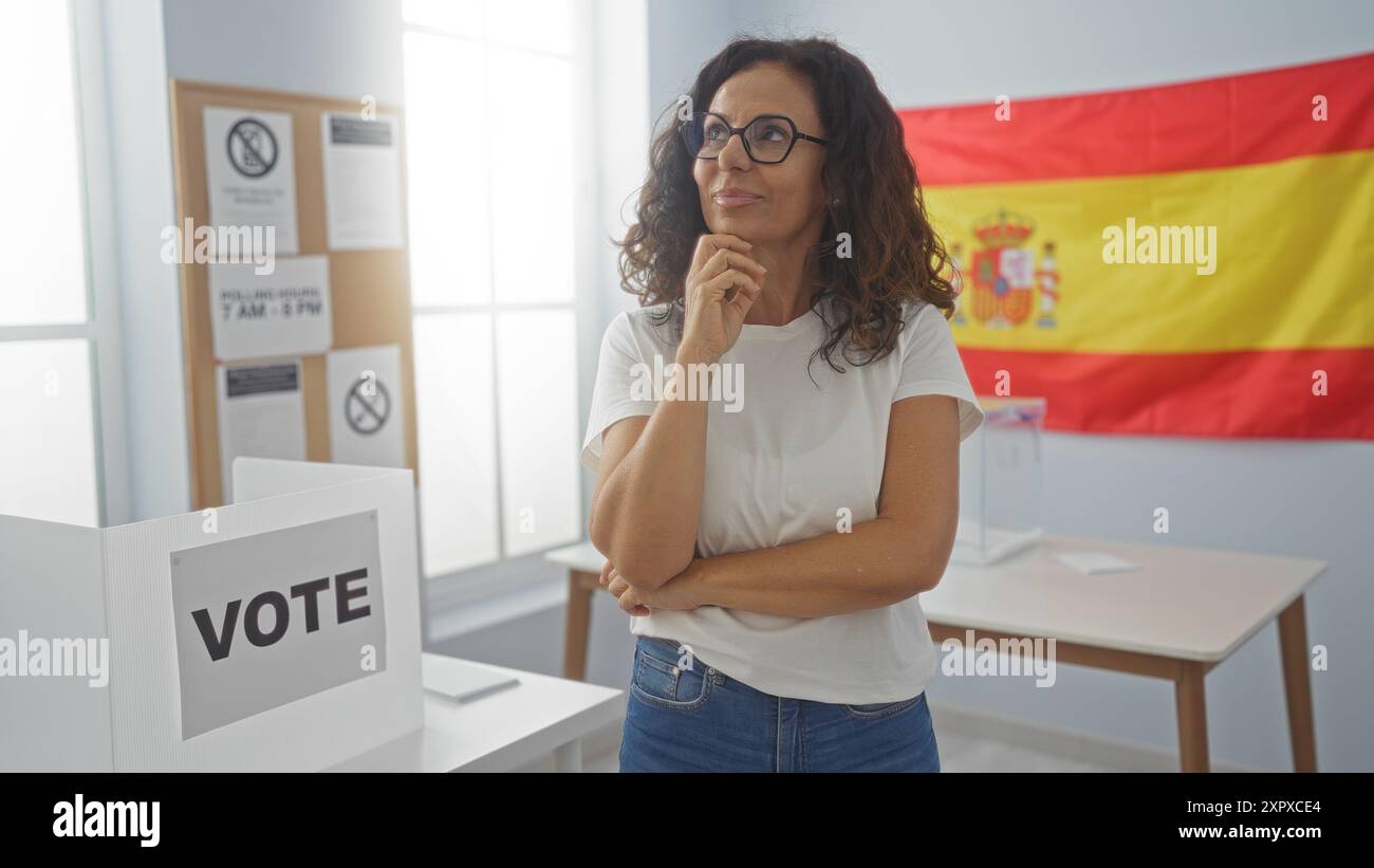Woman thinking inside an electoral room with a spanish flag, voting ...