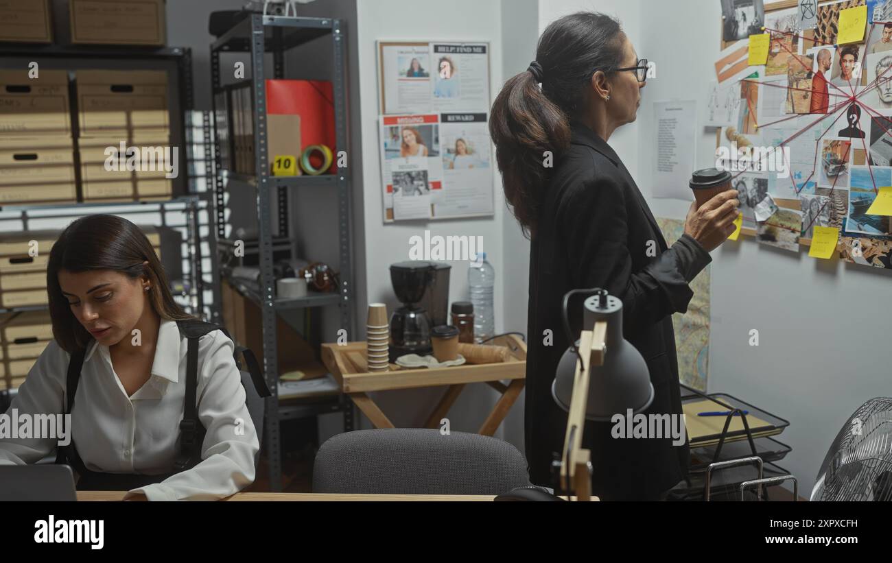 Two women detectives analyze evidence in a cluttered office space, with ...