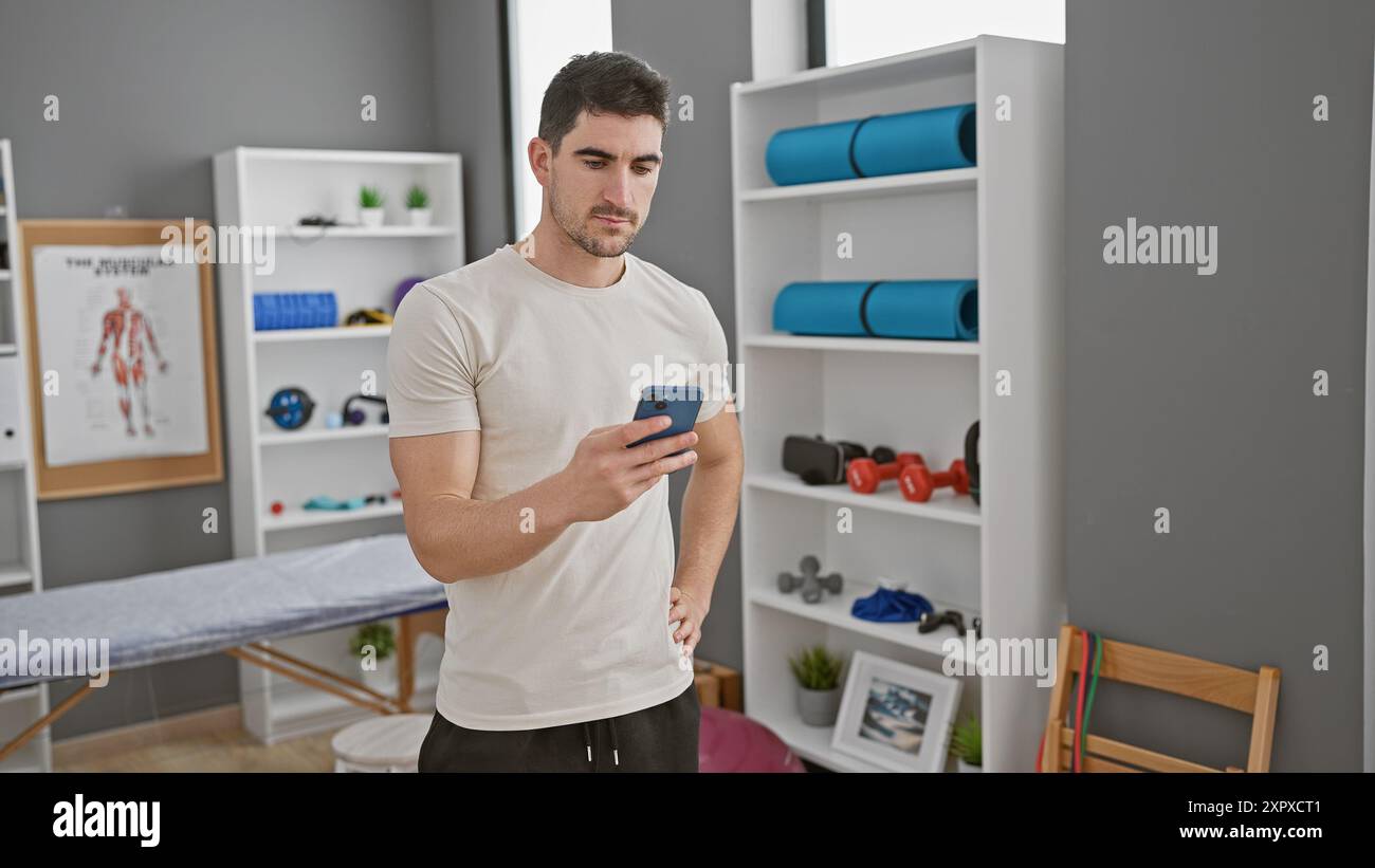 A handsome young hispanic man texting on a cellphone inside a well ...