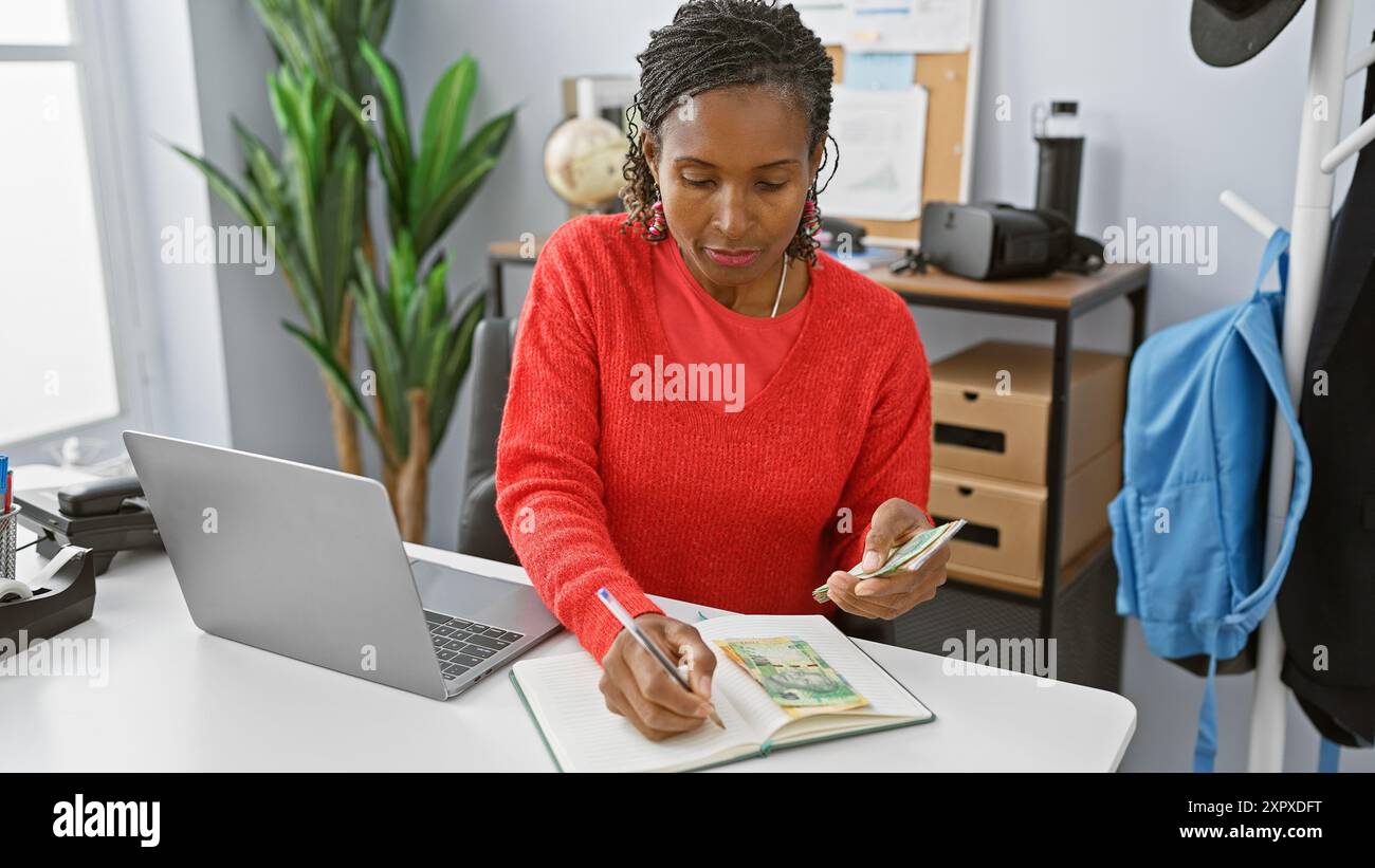 African woman budgeting with south african rands in a modern office ...