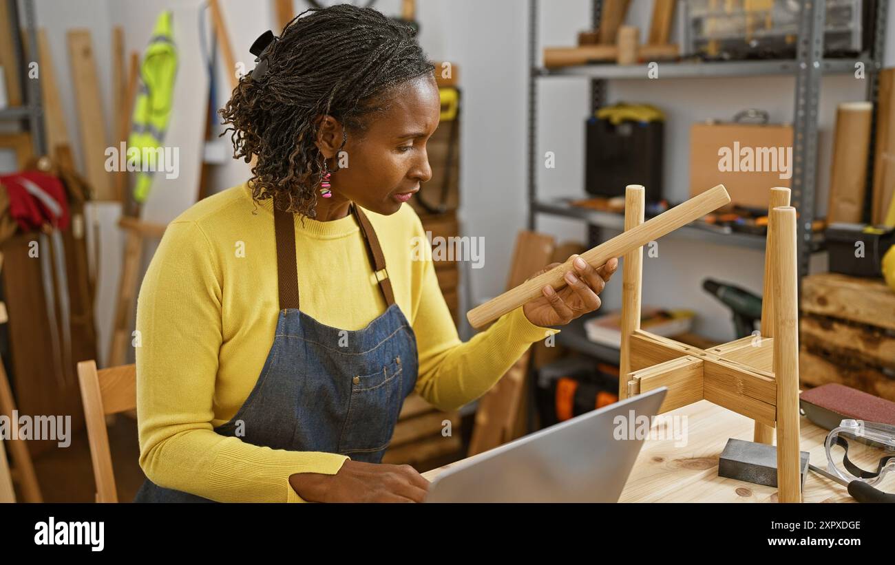 African american woman examines wood in a carpentry workshop surrounded ...