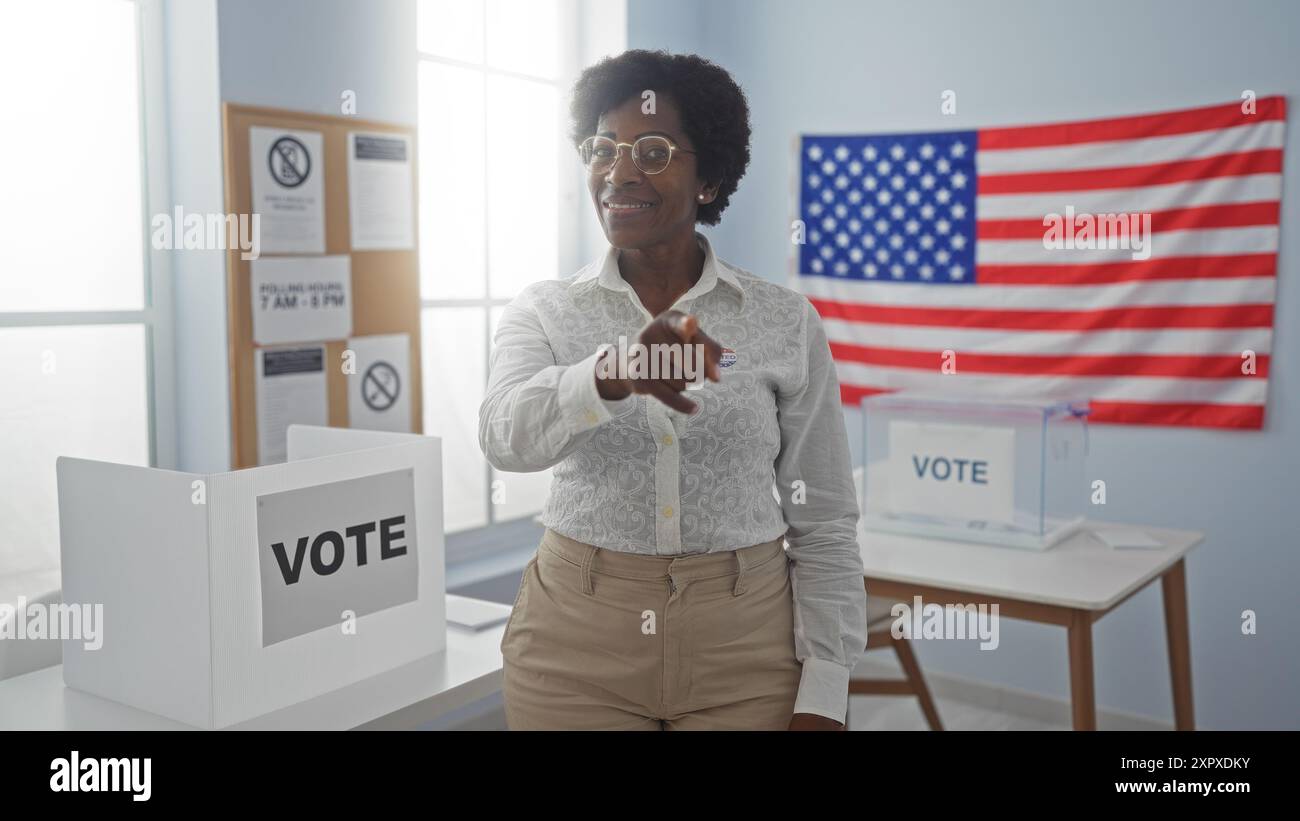 African american woman pointing at the camera in an indoor electoral ...