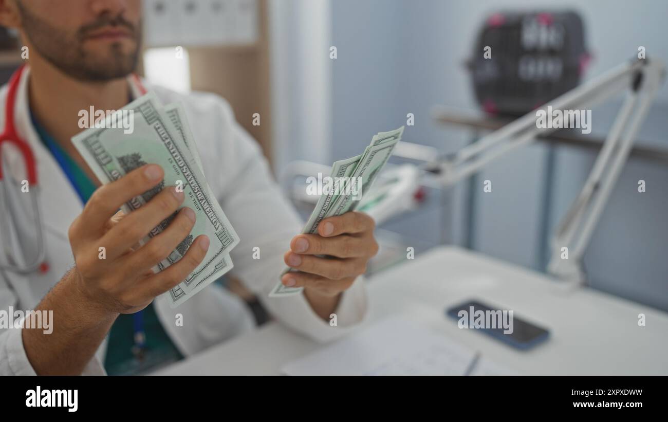 Handsome bearded man in a hospital counting us dollar bills in an ...
