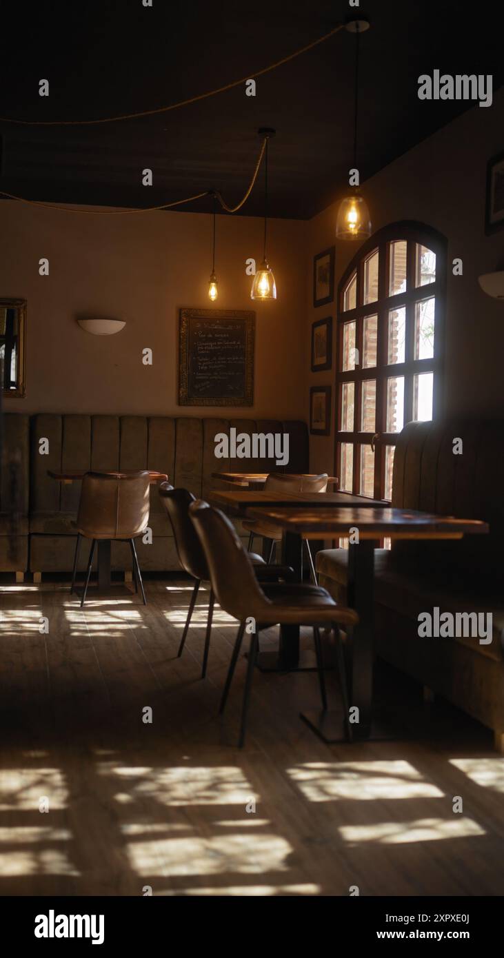 A cozy cafe interior with ambient lighting, featuring wooden furniture ...