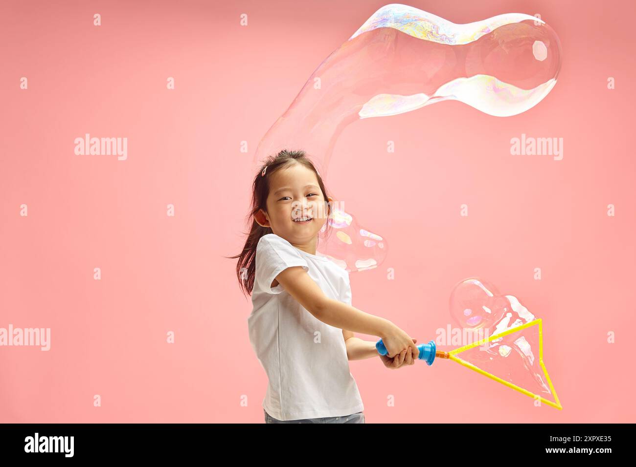 Cute Chinese Appearance Child Girl Creates Big and Long Soap Bubble on ...