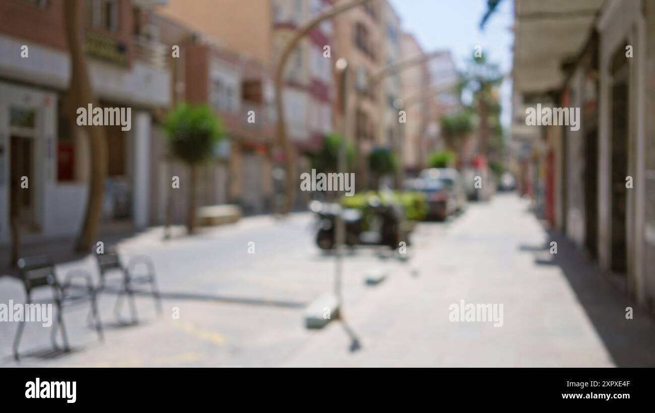 Blurred image of a city street showing out of focus buildings and trees ...