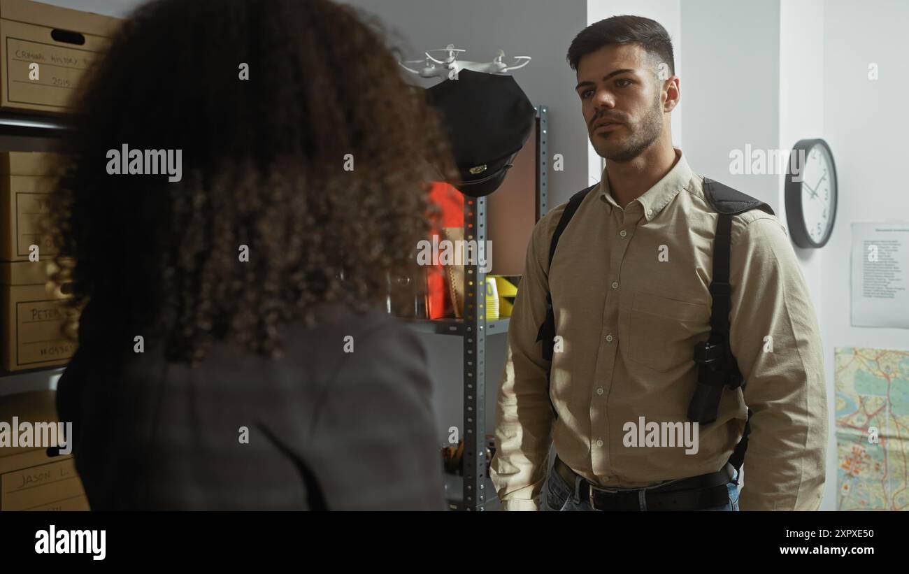 Male and female detectives in a police department room with evidence ...