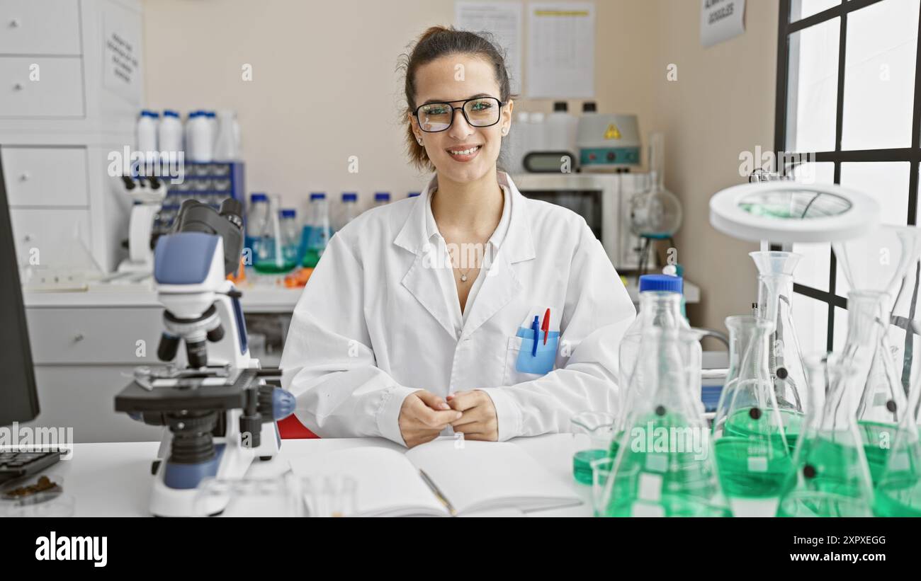 Young hispanic woman in labcoat hi-res stock photography and images - Alamy