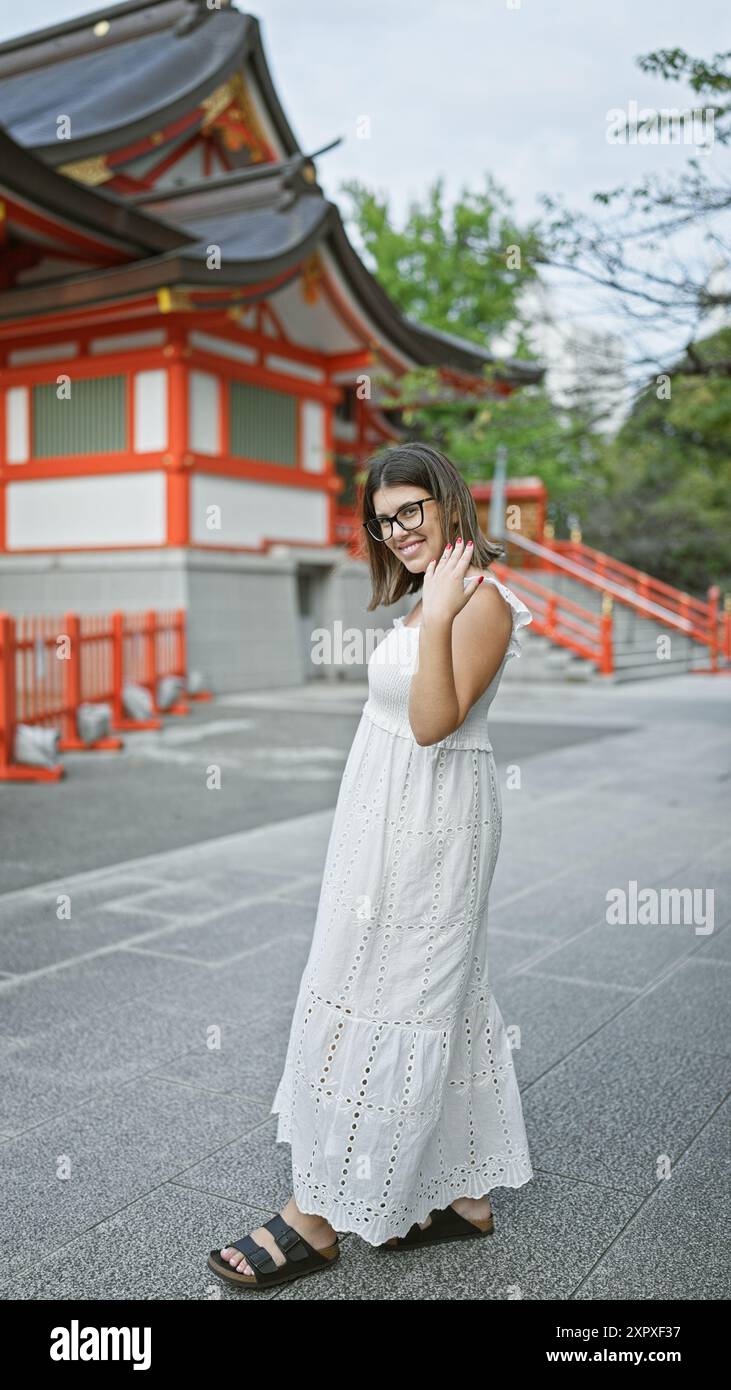 Cheerful and beautiful hispanic woman in glasses invites with friendly ...