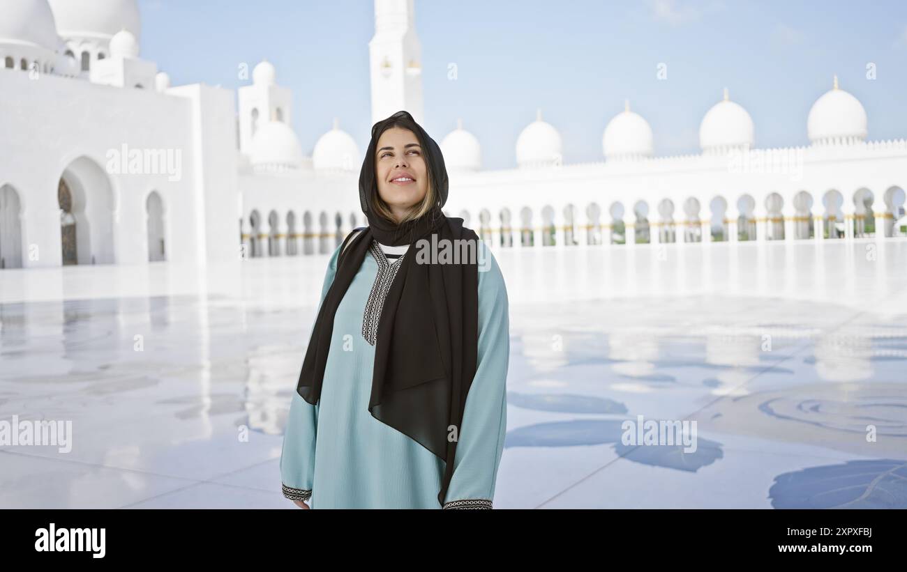Smiling woman wearing a hijab at abu dhabi's sheikh zayed grand mosque ...
