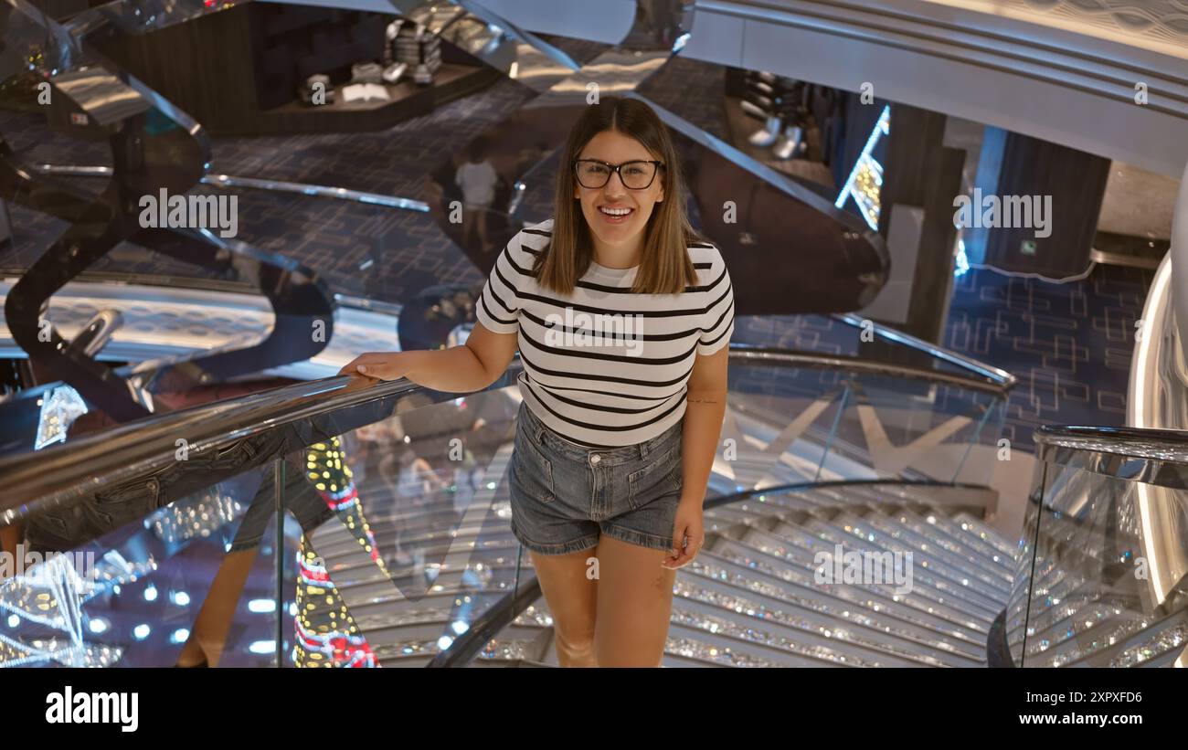 A cheerful young woman enjoying her luxurious vacation aboard a modern ...