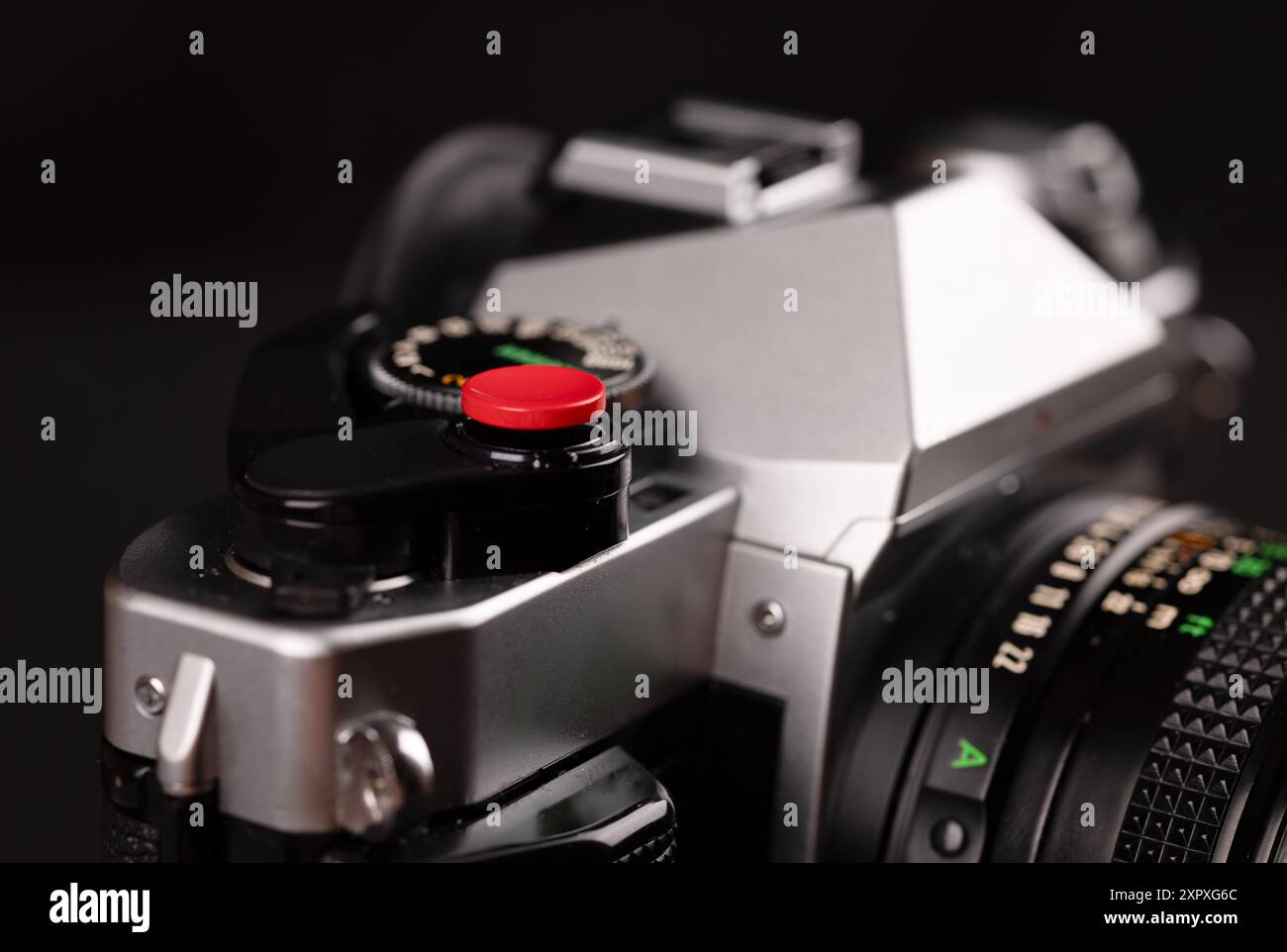 First-person view of an old camera emphasizing the red shutter button ...