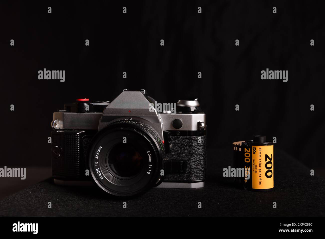 Detailed view of an old camera with a roll of 35mm film, placed on a ...