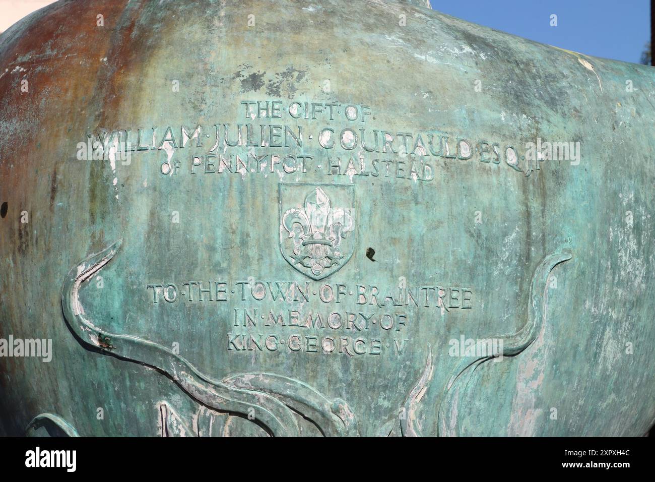 Dedication on the bronze statue of a young boy holding fish at centre ...