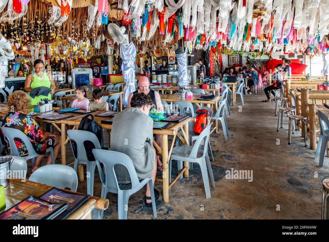 People sit and look at the menu at The Frandy Beach Bar and restaurant ...