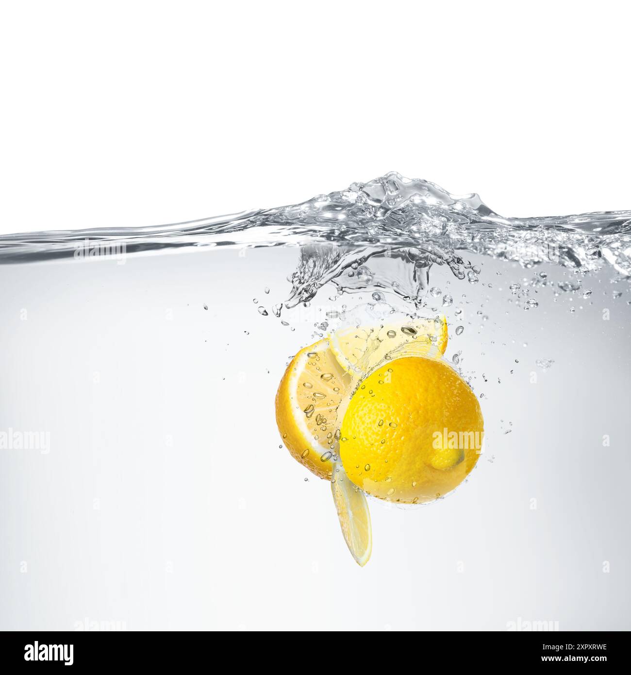 Fresh lemons falling into water on white background Stock Photo - Alamy