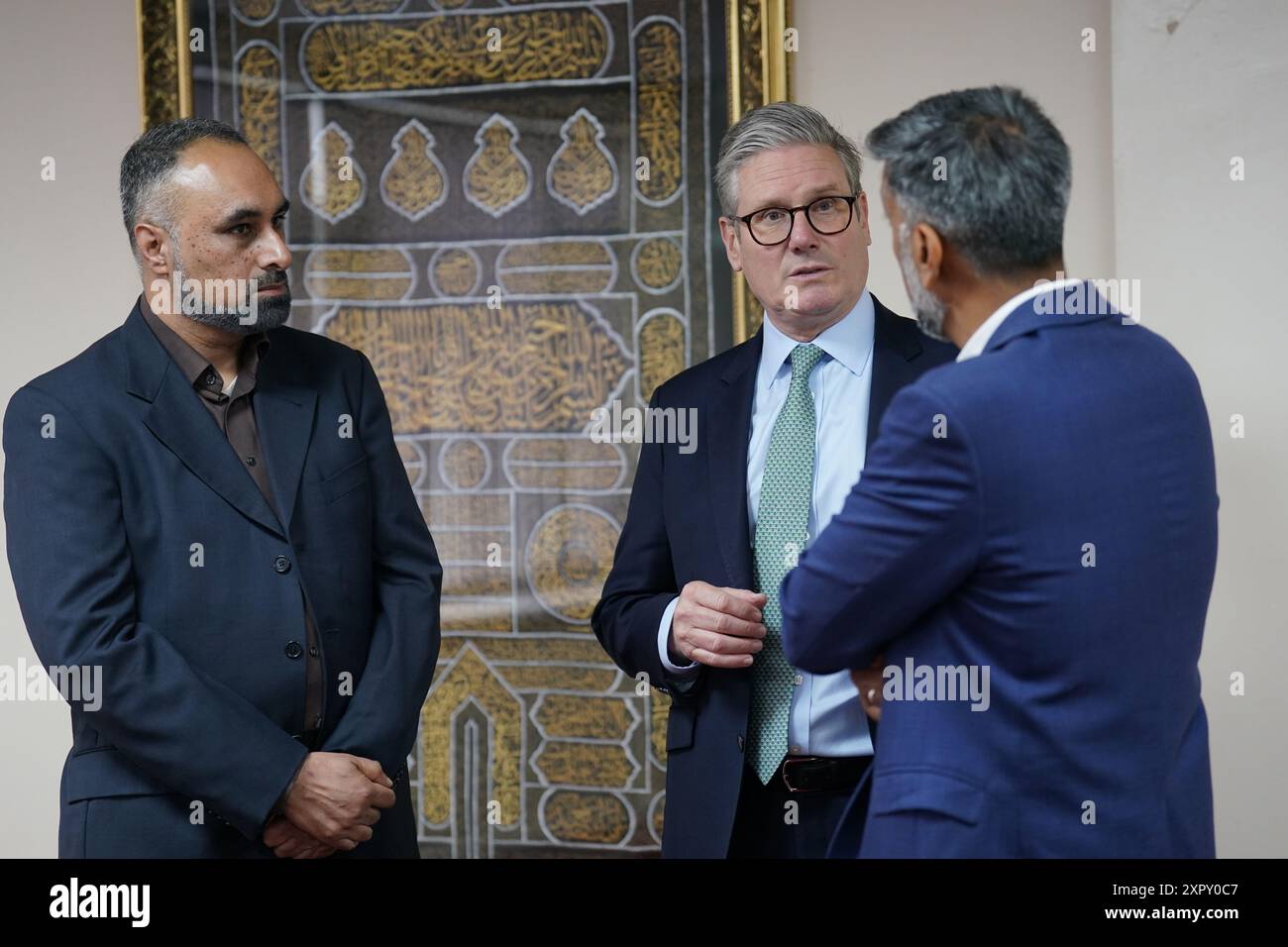 Prime Minister Sir Keir Starmer (centre) with Jehangir Malik (right ...