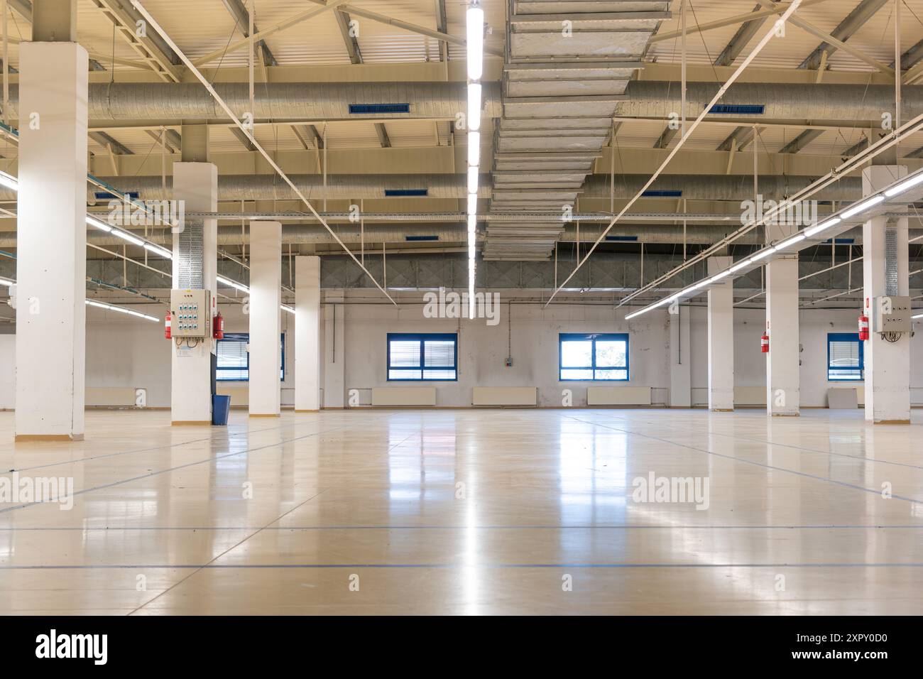Closed down empty factory interior manufacturing hall with tall ceiling ...