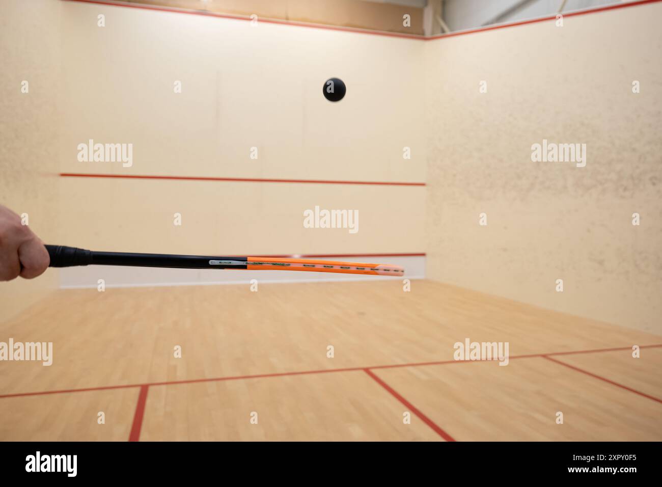 Squash racket and ball inside court, ball bouncing off the racket Stock ...