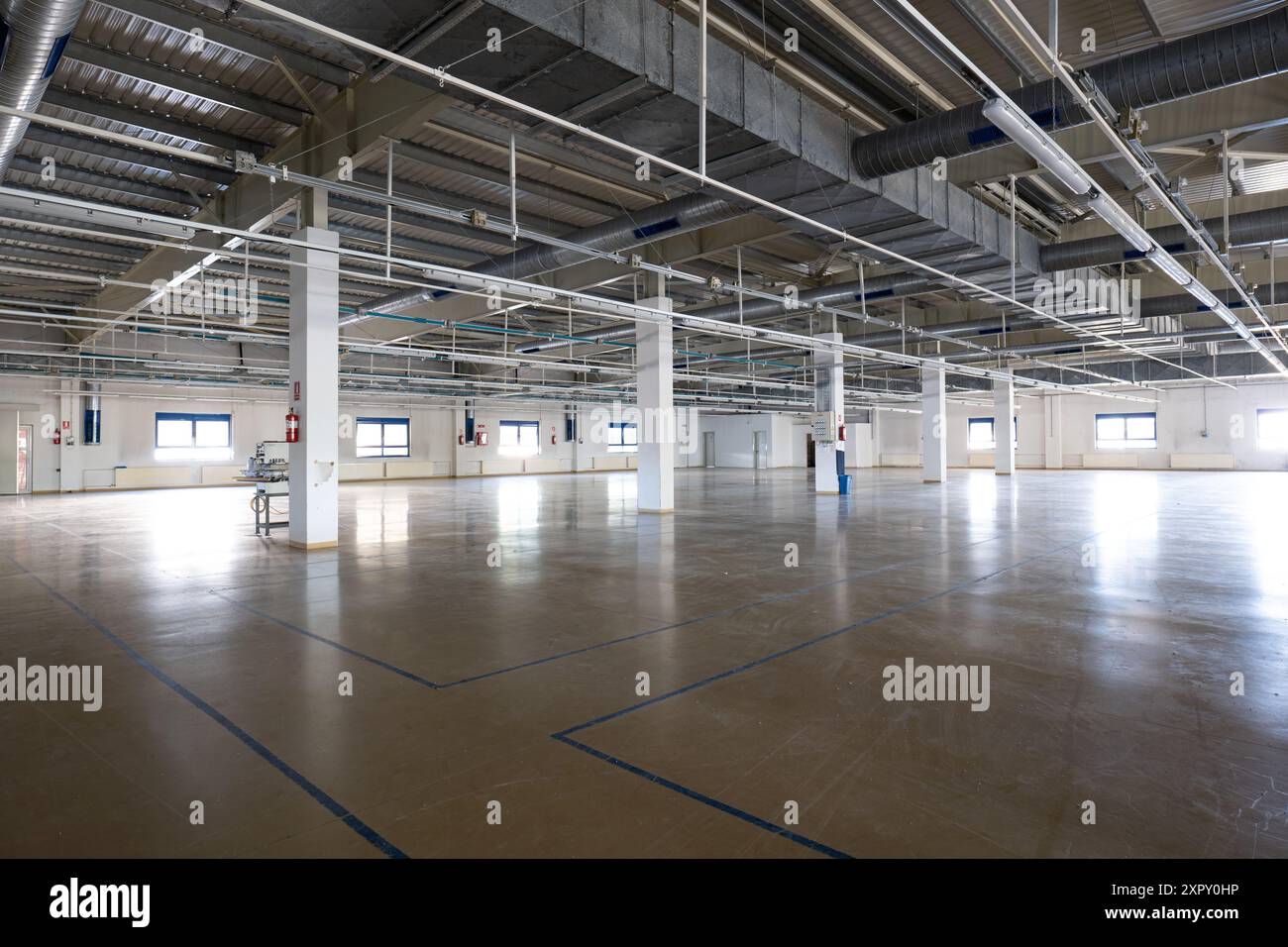Closed down empty factory interior manufacturing hall with tall ceiling ...