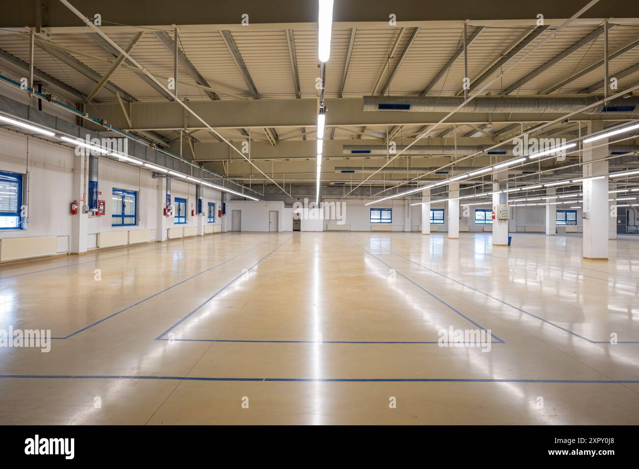 Closed down empty factory interior manufacturing hall with tall ceiling ...
