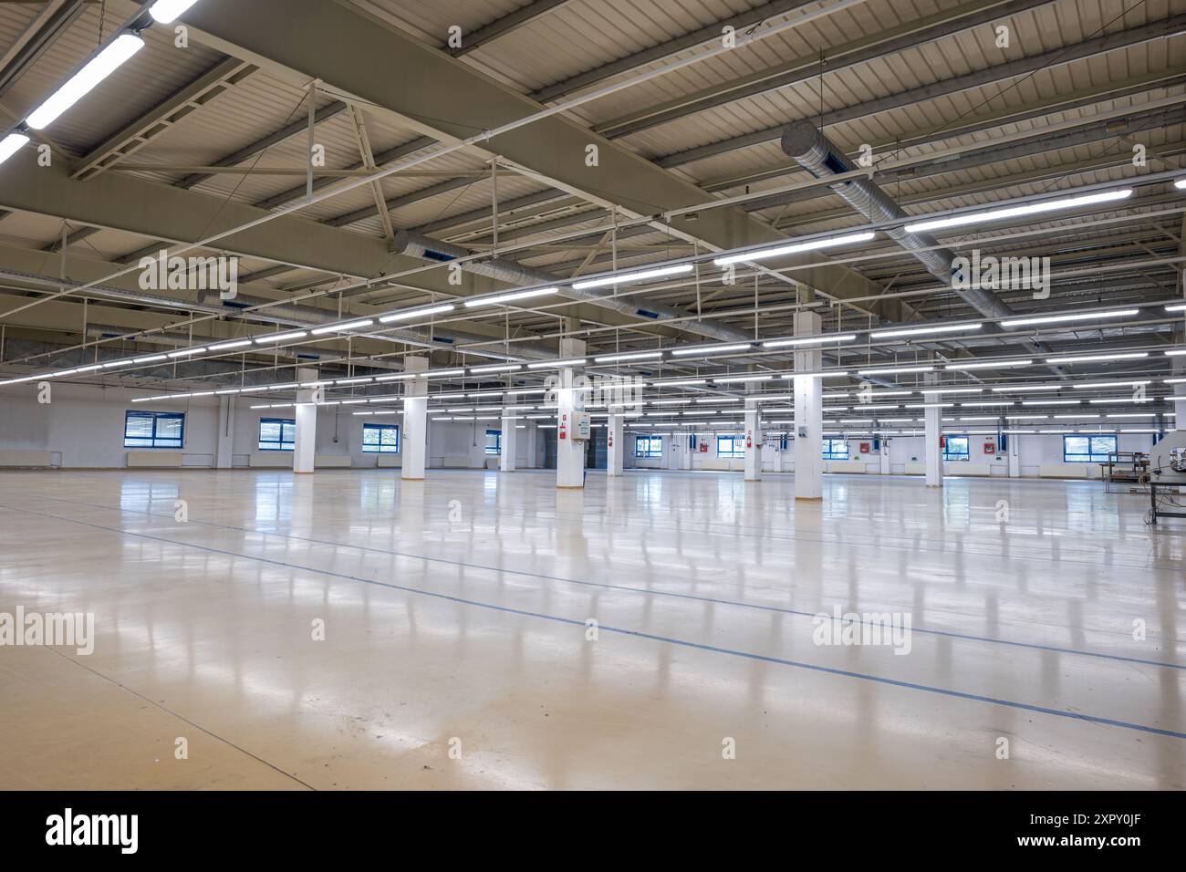 Closed down empty factory interior manufacturing hall with tall ceiling ...