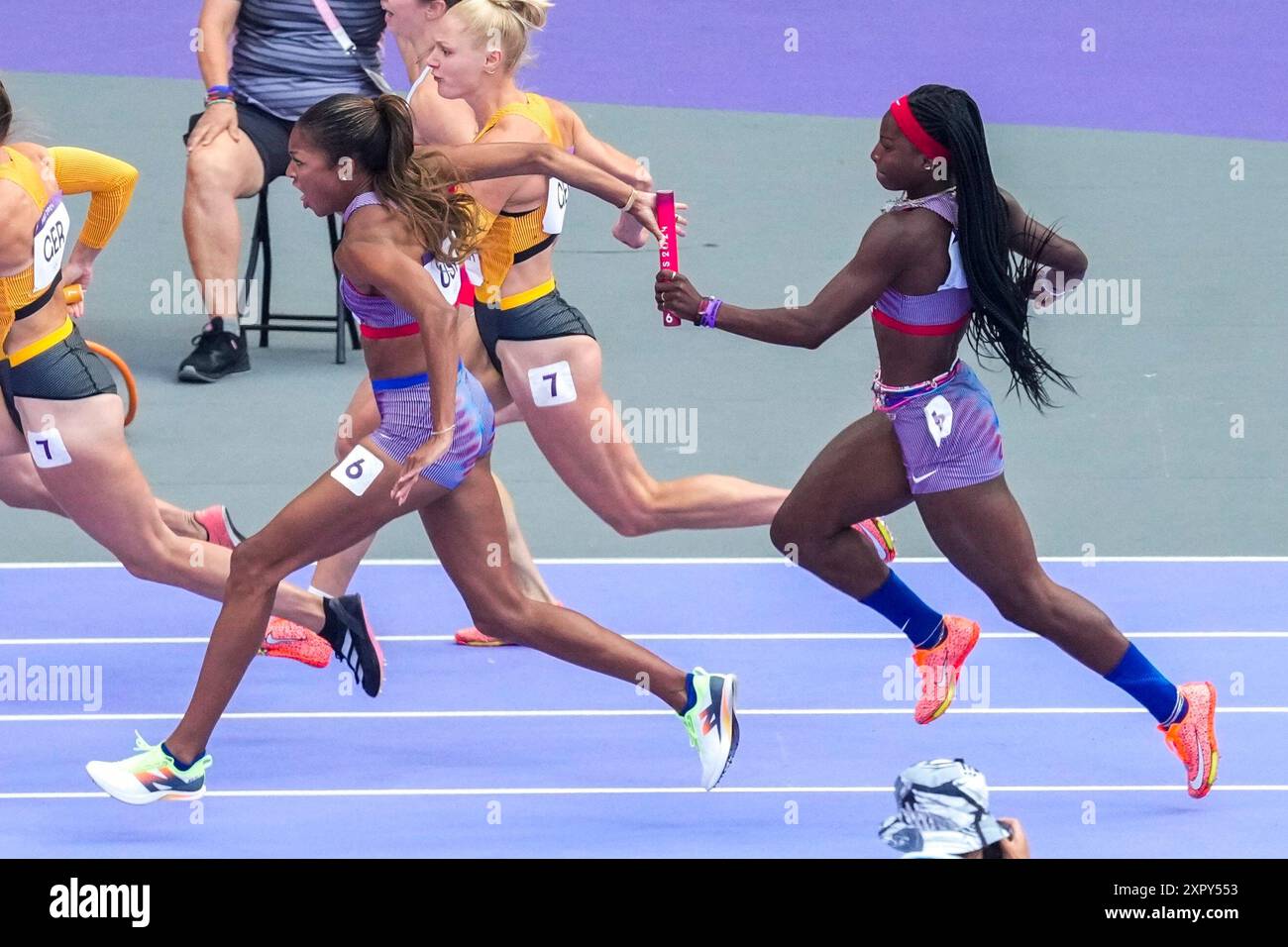United States' Twanisha Terry, right, gives the baton to teammate Gabby ...