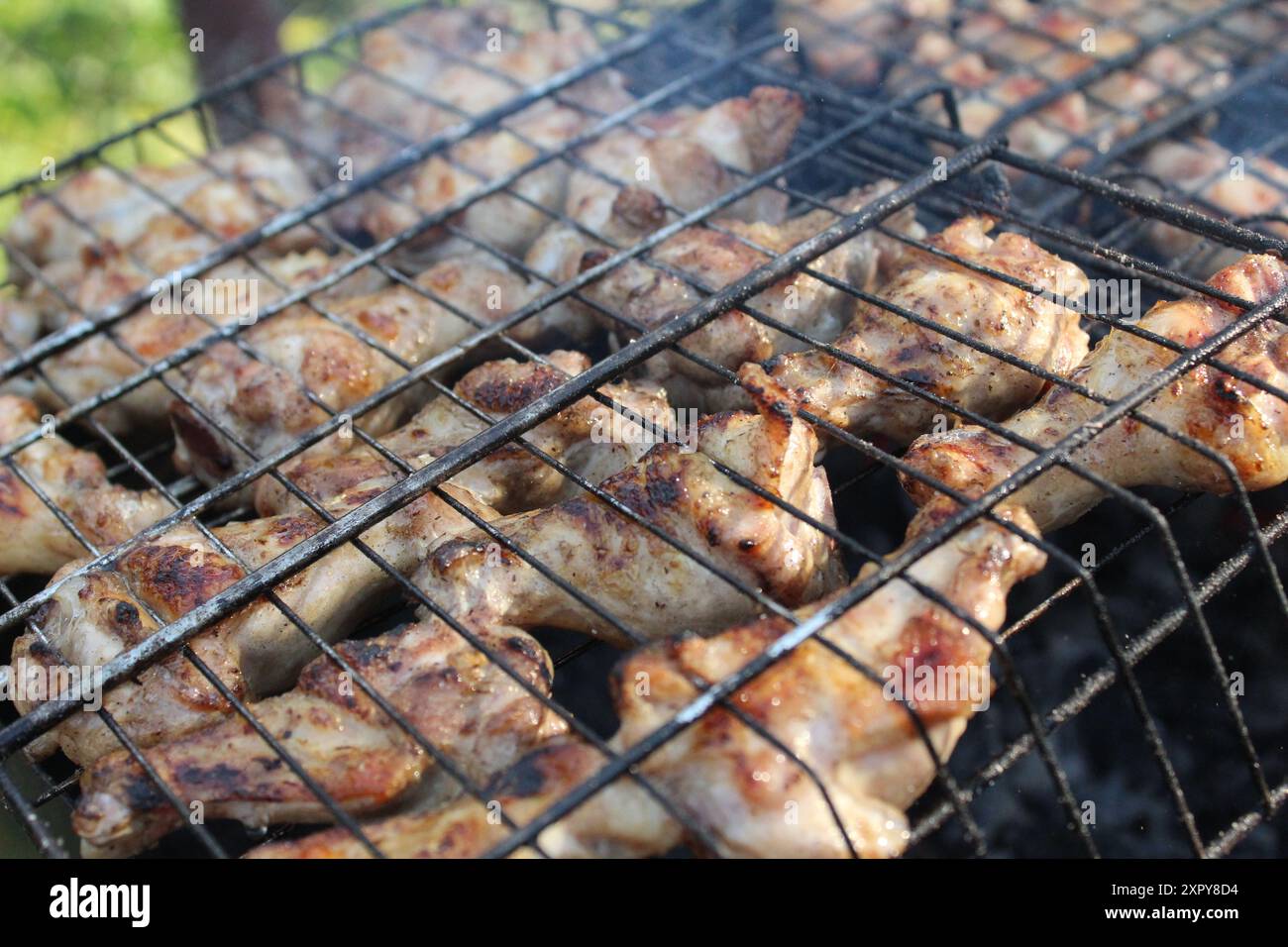 Cooking chicken on a grill grate. Cooking meat on an open fire grill ...