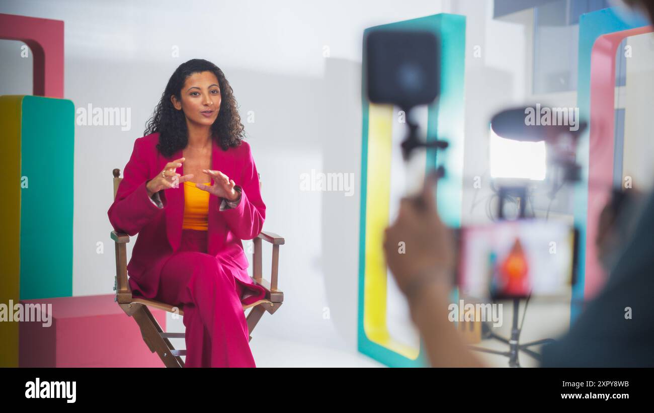 Vibrant Scene Captures A Black Female Host In A Pink Suit, Engaging ...
