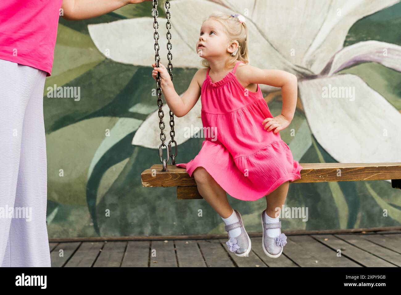 Child walks with cochlear implant system. Installation cochlear implant ...