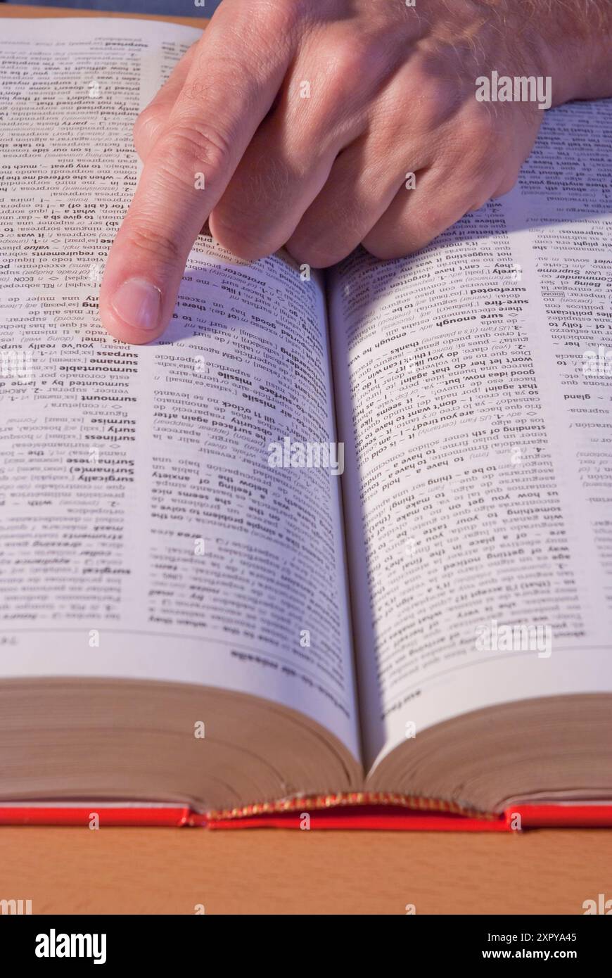 Man's hand looking up a word in the dictionary. Close view Stock Photo ...