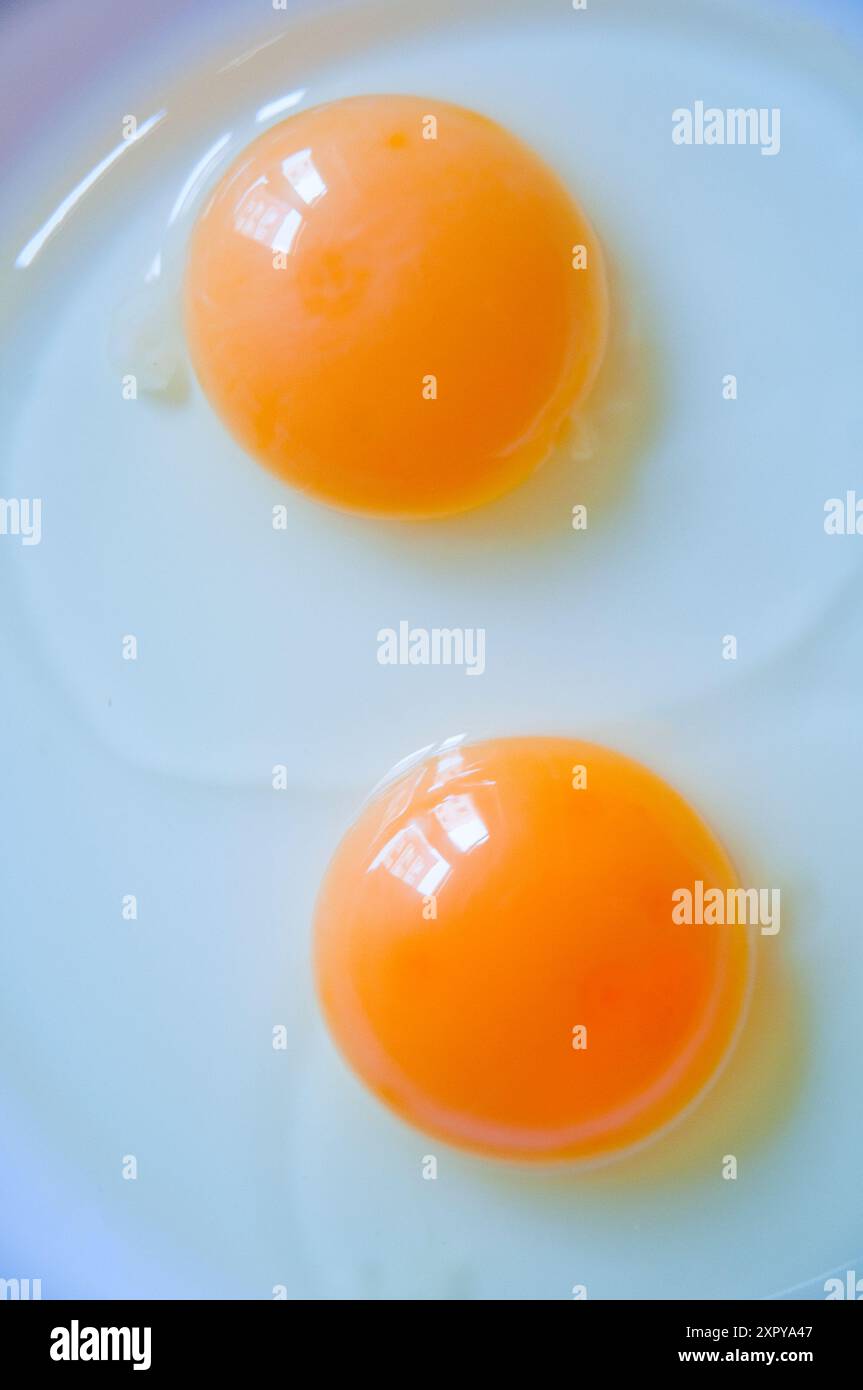 Two egg yolks. Close view Stock Photo - Alamy