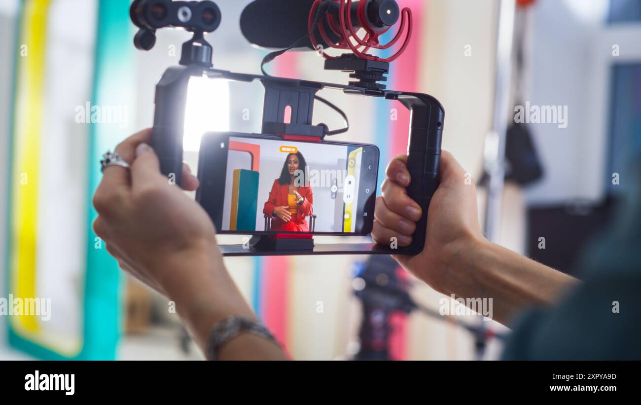 Young Female South Asian Host In Red Suite Engaging In Lively ...