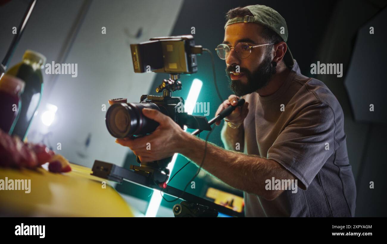 Focused Male Cinematographer With Beard And Glasses Operates ...